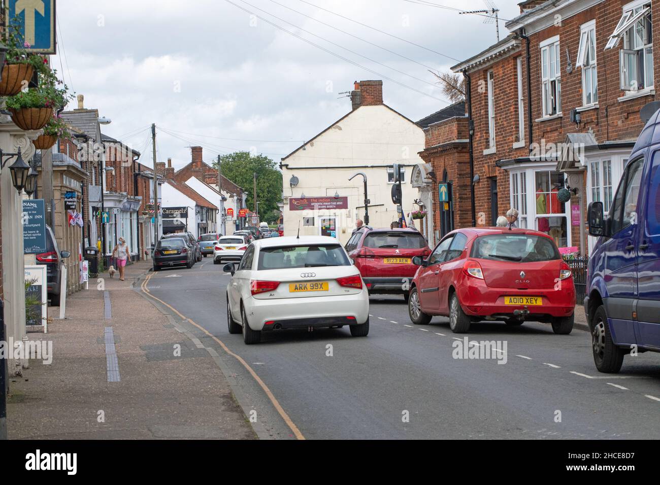 Stalham High Street. Traffic hold up. Few pedestrians. Limited parking ...