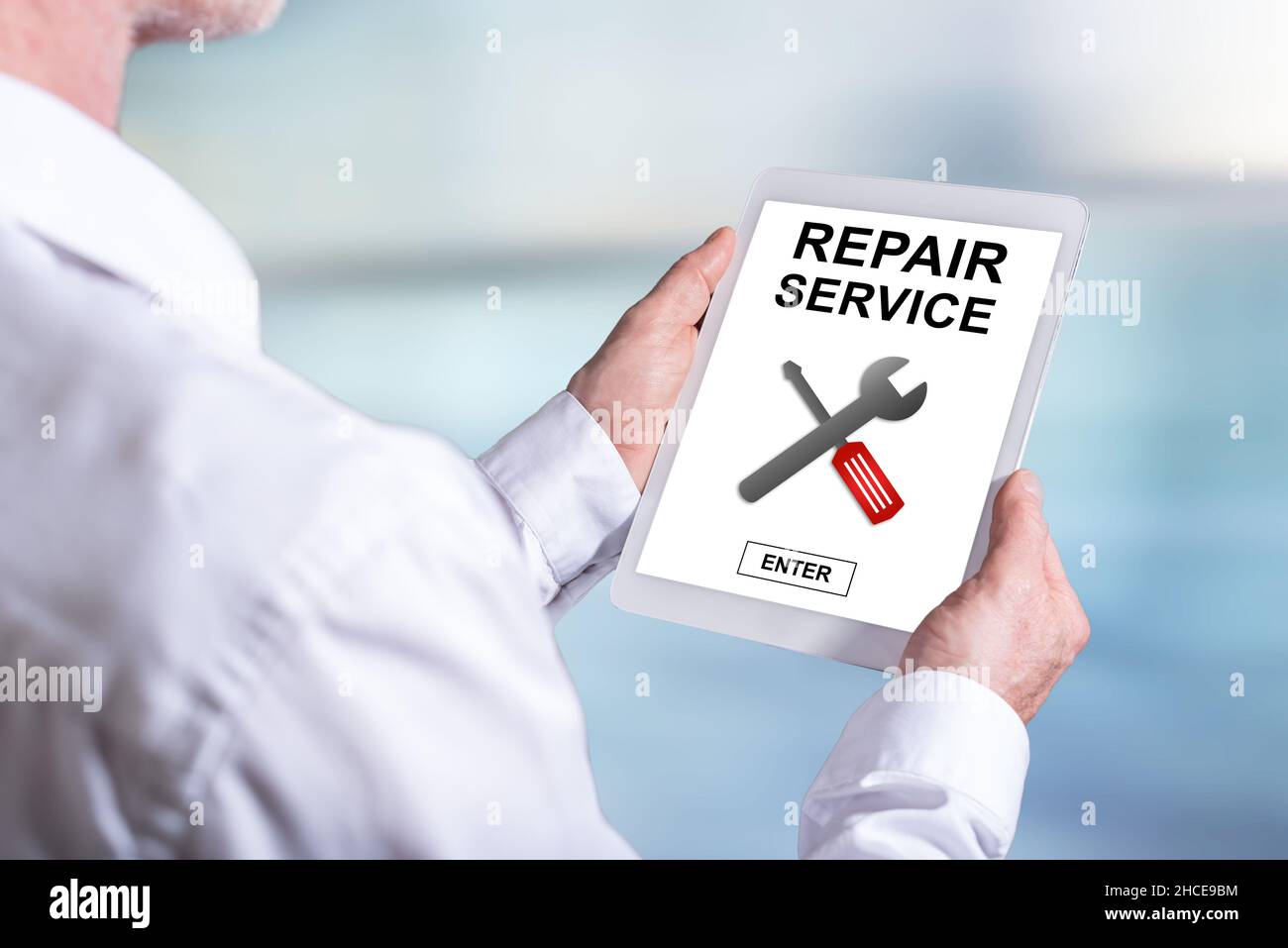 Tablet screen displaying a repair service concept Stock Photo - Alamy