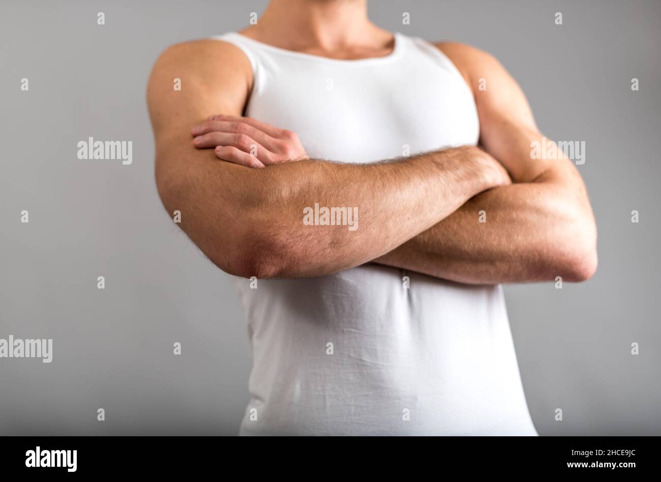Athletic man with crossed arms Stock Photo - Alamy