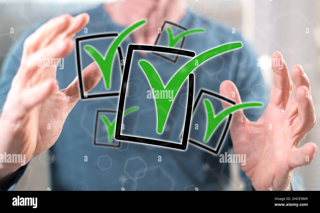 Validation concept between hands of a man in background Stock Photo - Alamy