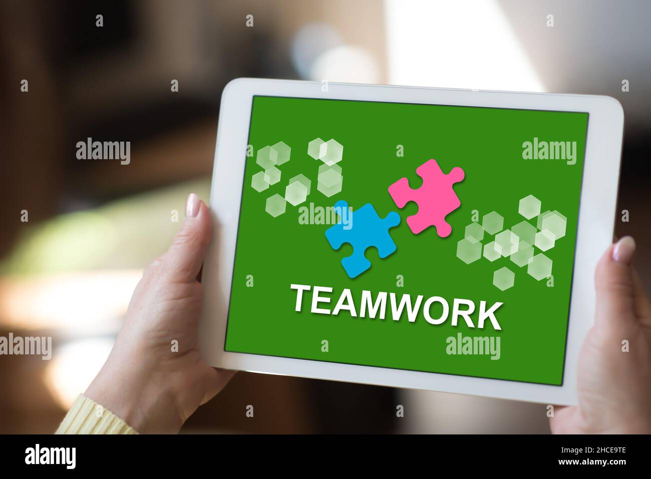 Tablet screen displaying a teamwork concept Stock Photo - Alamy