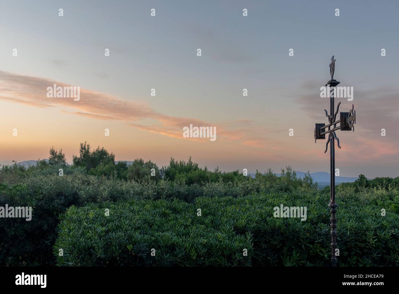 catholic iron cross at sunset in the medieval village of pals on the ...