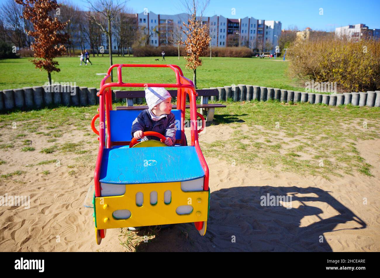 Young boy sitting in a car-shaped spring swing equipment in the Jan ...