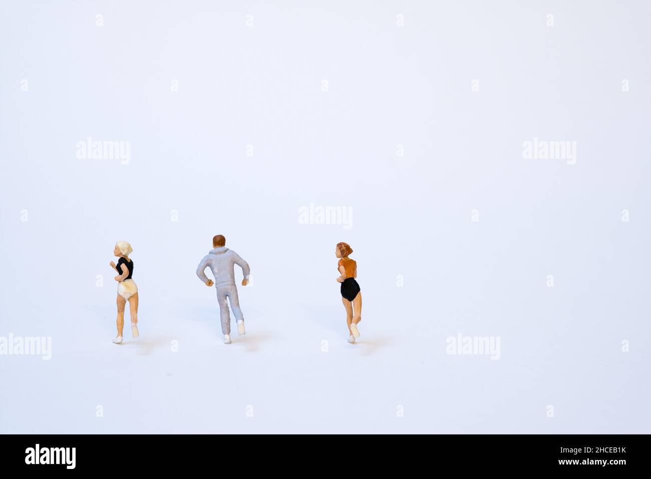 Miniature runners while running, training, competing - white background ...