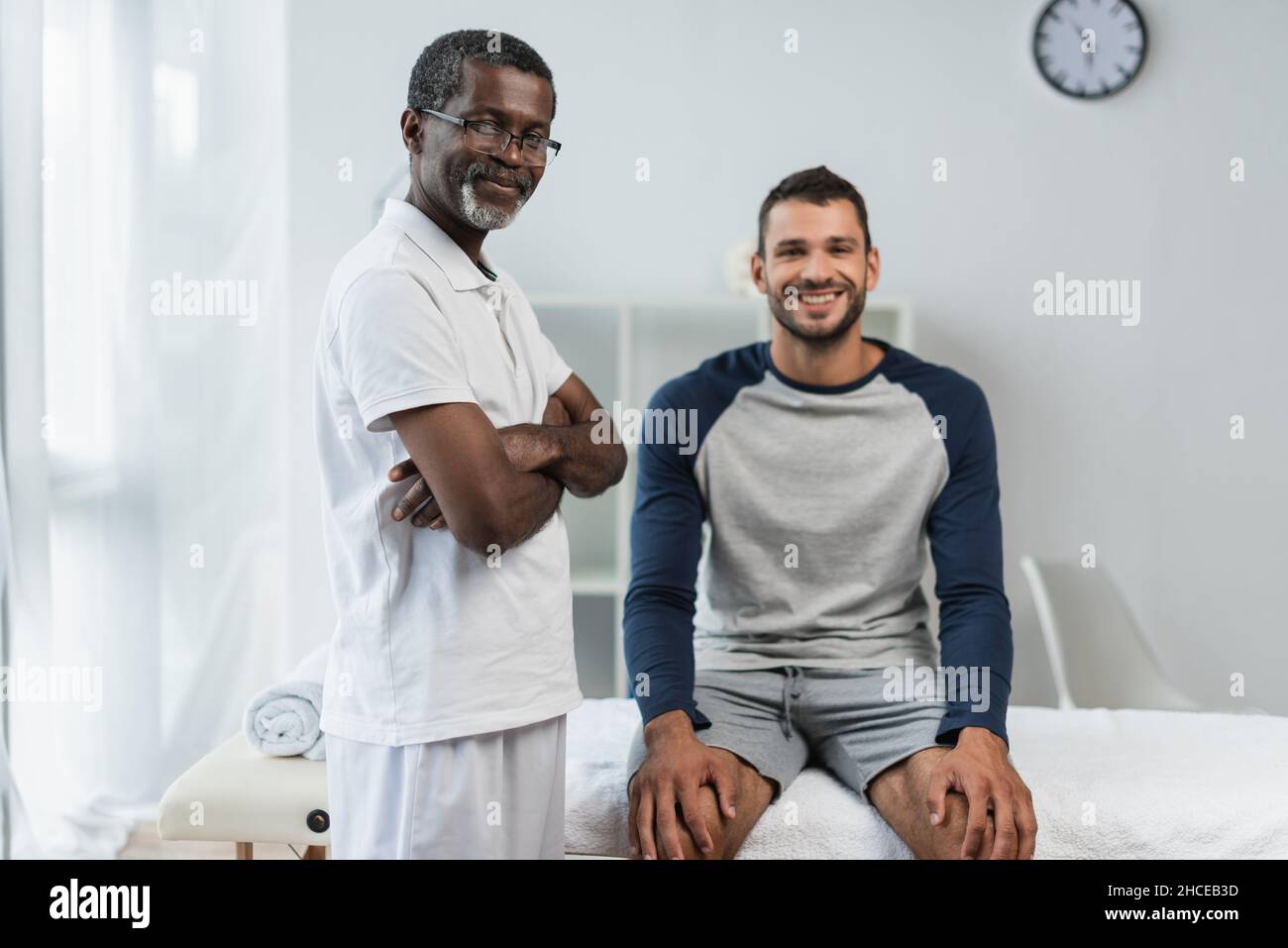 happy african american doctor and cheerful patient looking at camera in ...