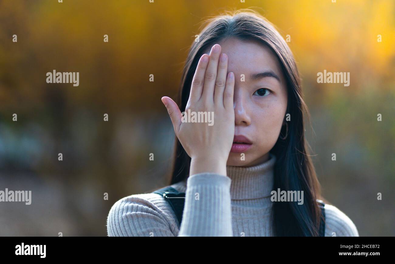 Hand covering eye hi-res stock photography and images - Alamy