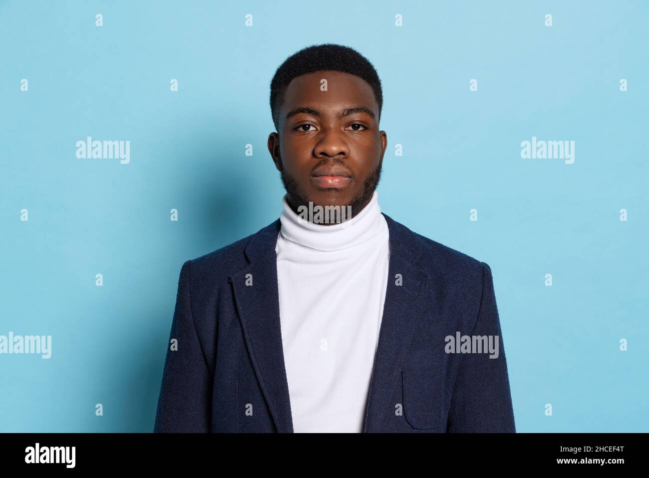 Half-length portrait of young stylish african man, student wearing ...