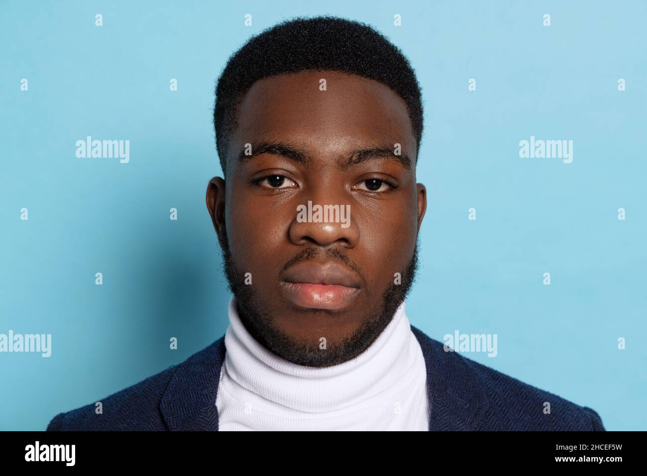 Half-length portrait of young stylish african man, student wearing ...