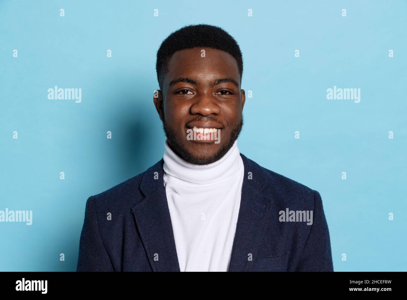 Half-length portrait of young stylish african man, student wearing ...