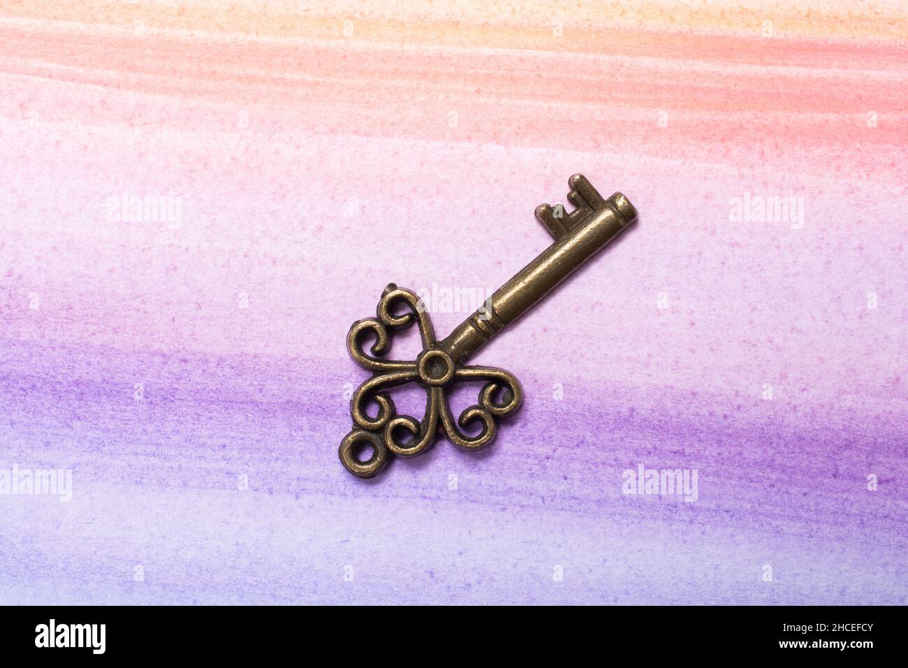 Small vintage key in the colorful pastel background Stock Photo - Alamy