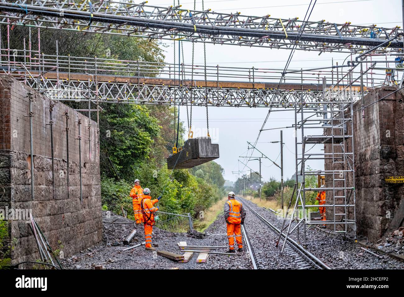 Railway workers building new railway and knocking down bridges Stock ...