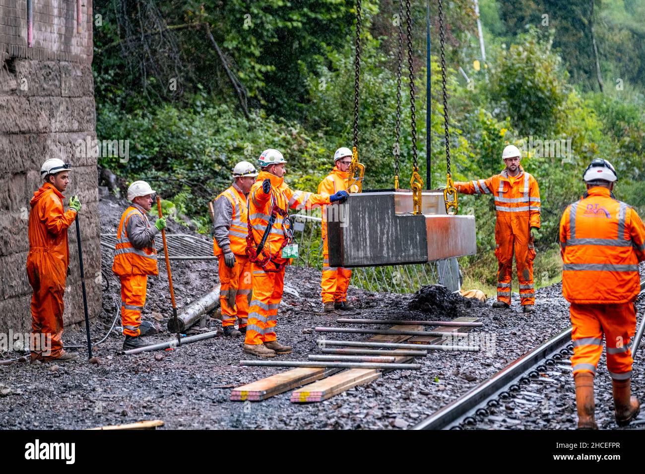 Railway workers building new railway and knocking down bridges Stock ...