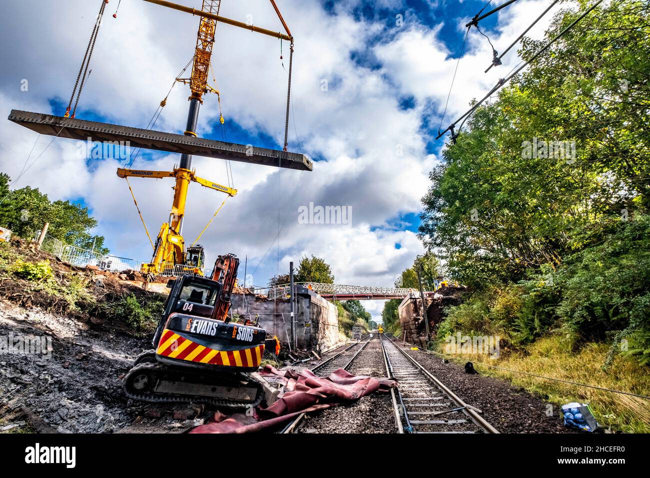 Railway workers building new railway and knocking down bridges Stock ...
