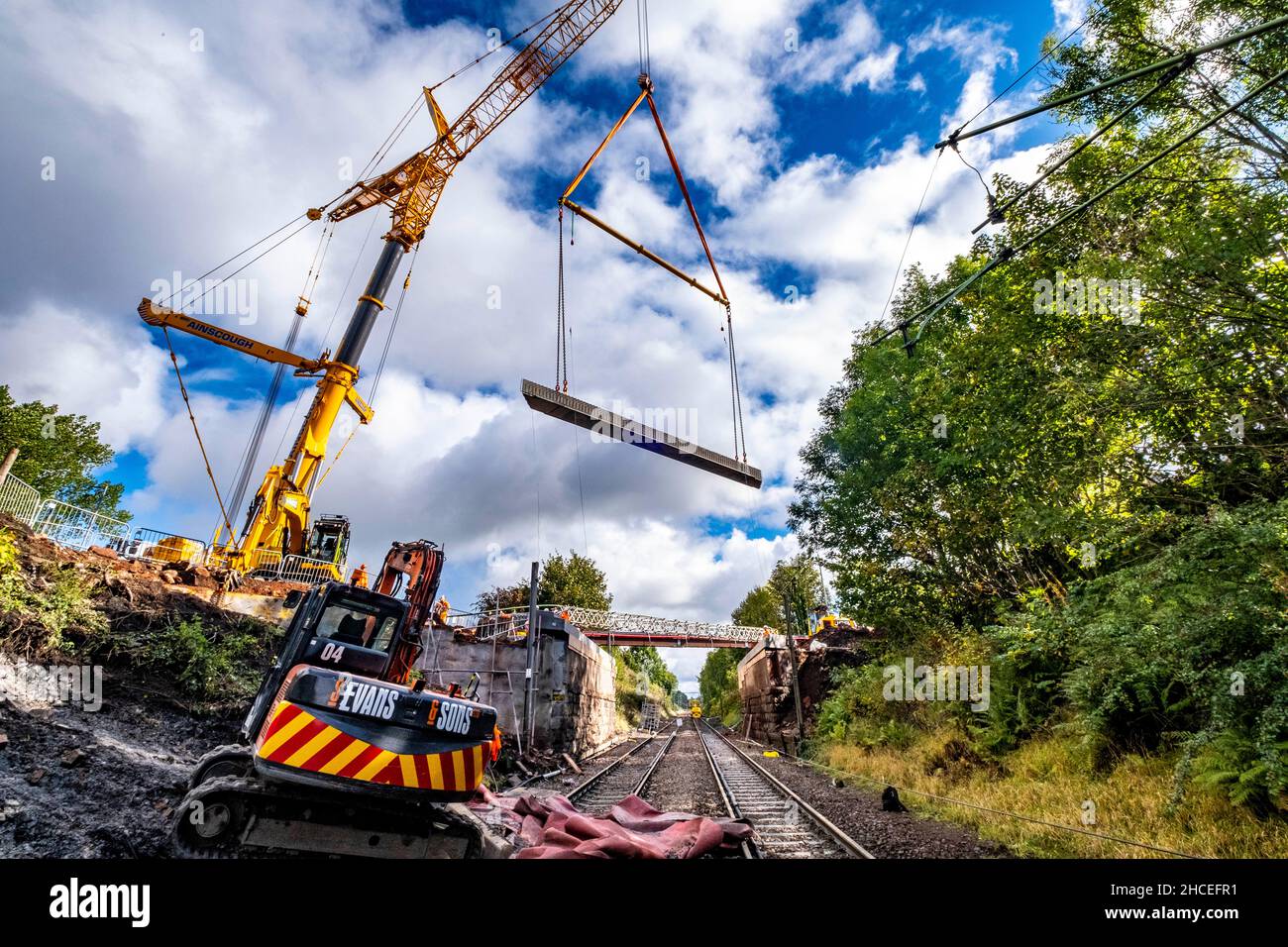 Railway workers building new railway and knocking down bridges Stock ...