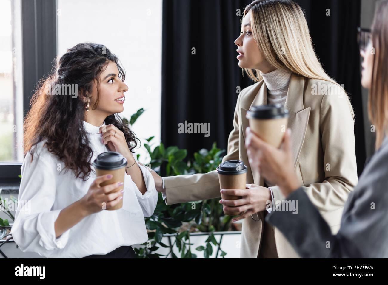 Holding coffee cups papers women hi-res stock photography and images ...