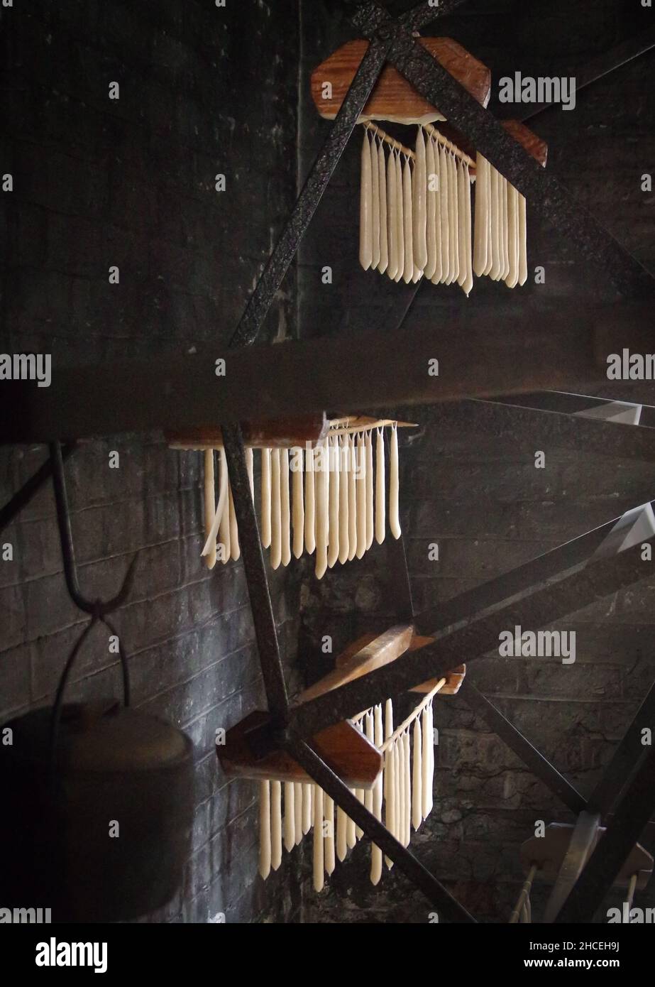 Wax candles hanging on a candle makers frame Stock Photo - Alamy