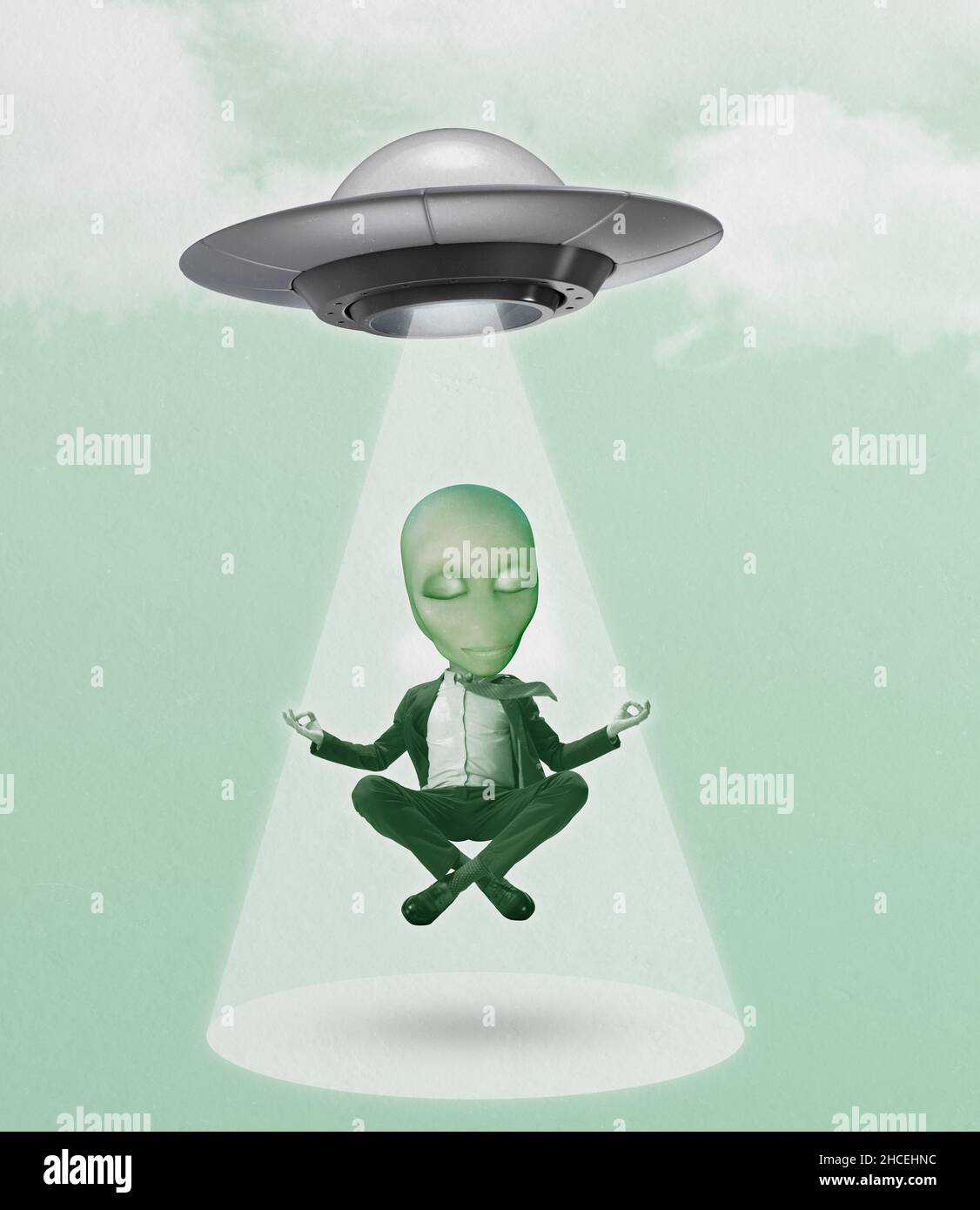 Green alien with human body sitting in lotus position and meditates in ...