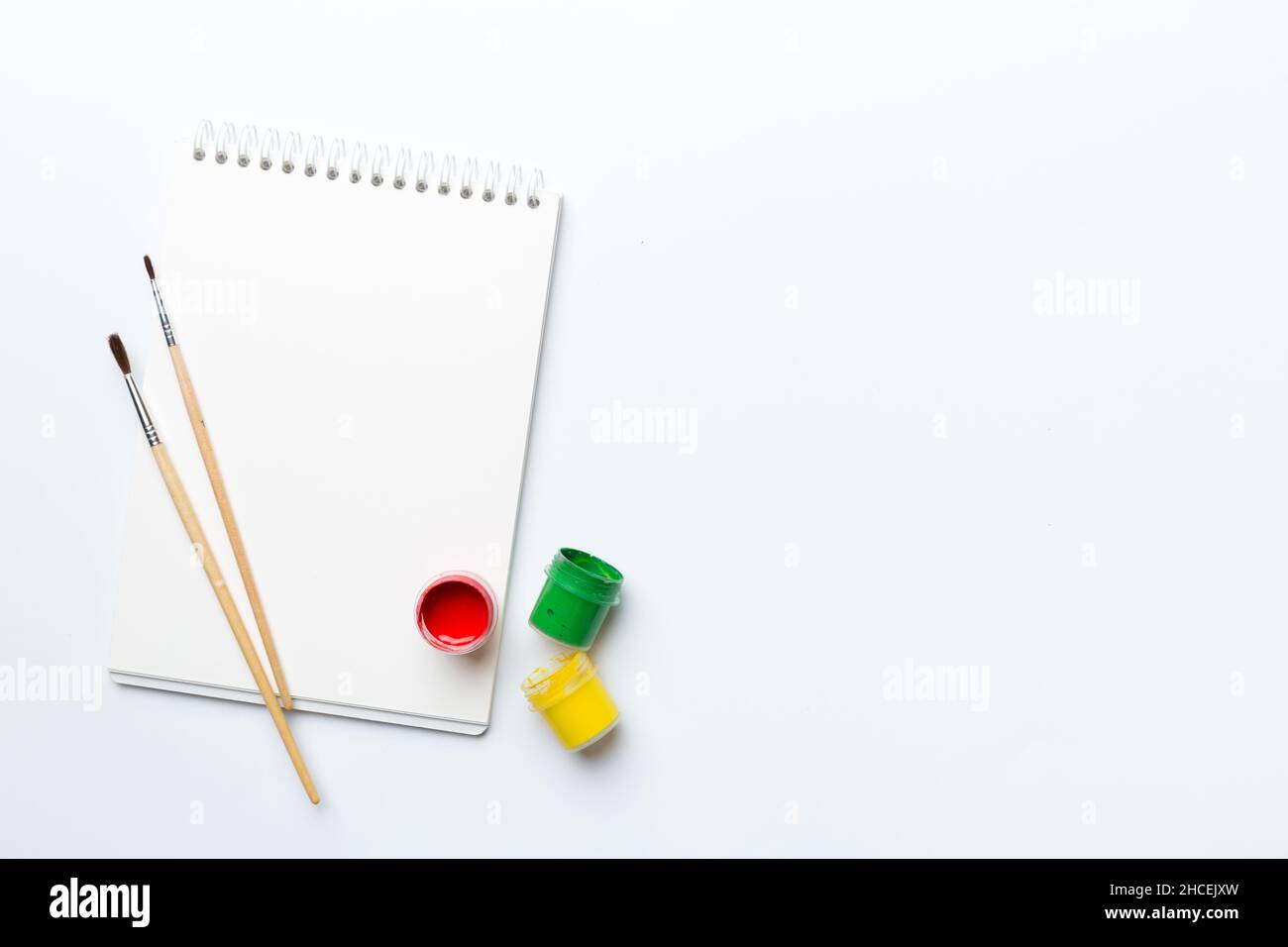 Album pages and paints, pencils, brush on a colored background. Top ...