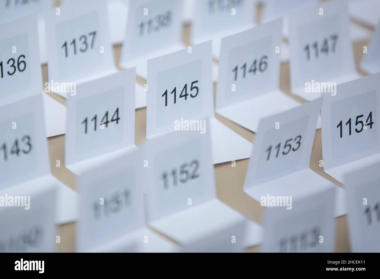 Different numbers printed on sheets of papers organized in a row Stock ...