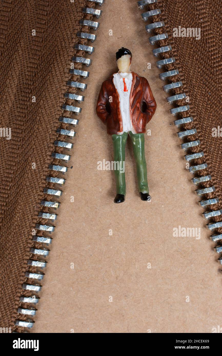 A man figure and open zipper in the light brown background Stock Photo ...