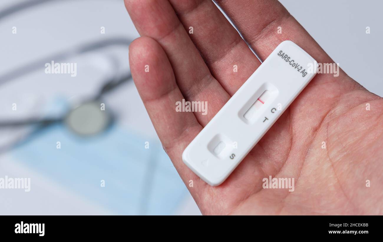 Hand holding a negative covid antigen rapid test Stock Photo - Alamy