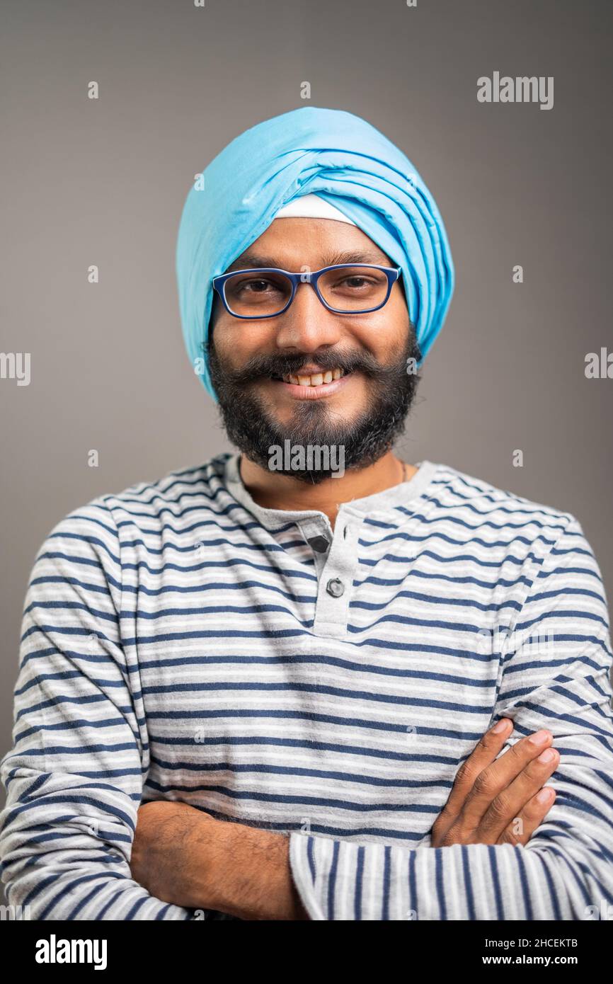 Happy smiling Indian sikh man with crossed arms looking at camera on ...
