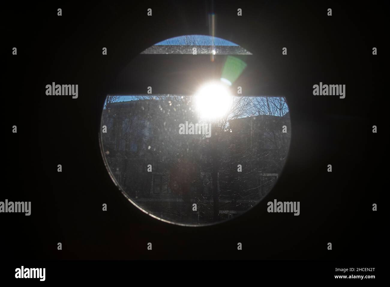 Round window at sunrise Stock Photo - Alamy