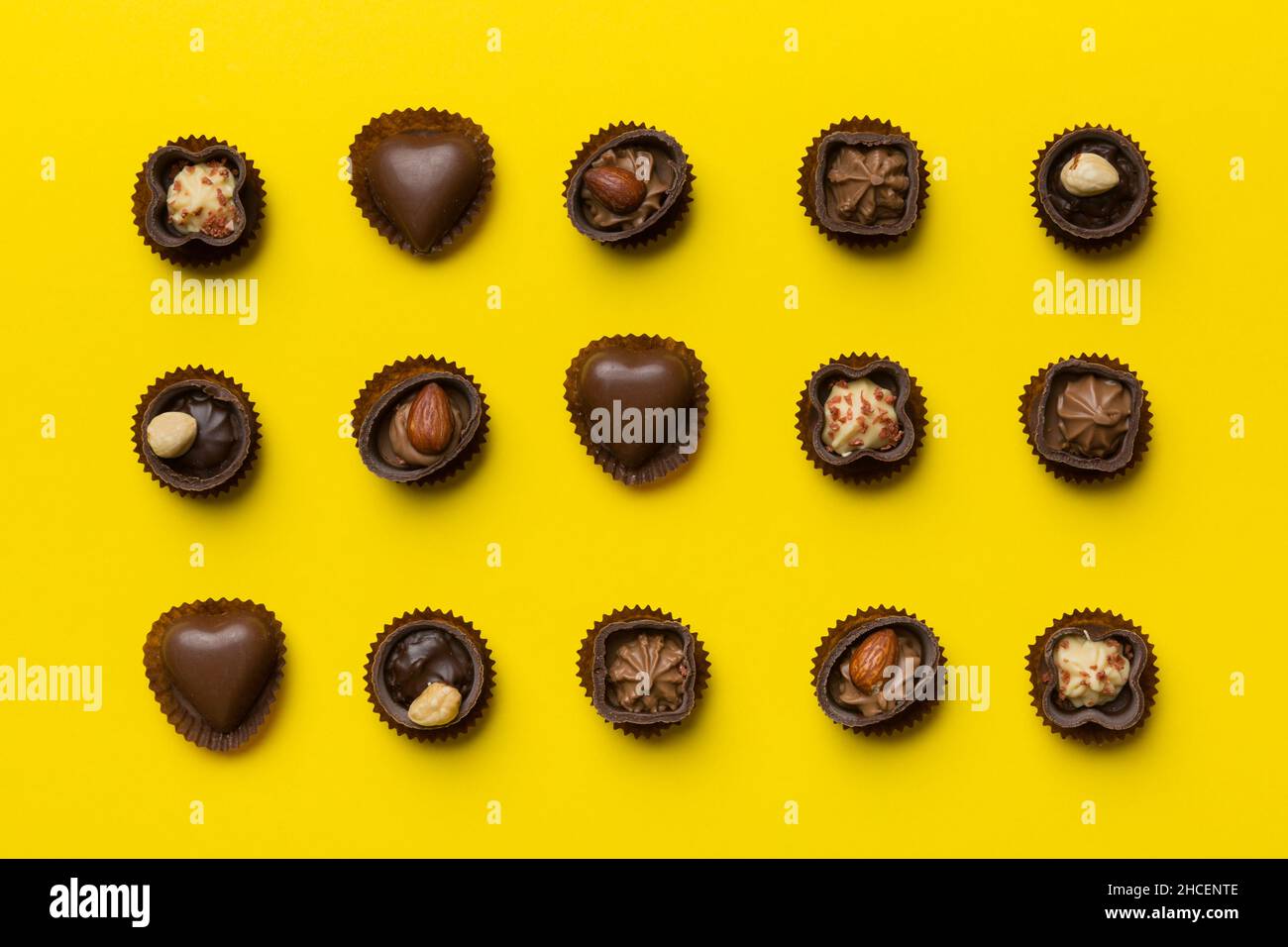 Different kinds of chocolates on colored table close-up. Top View and ...