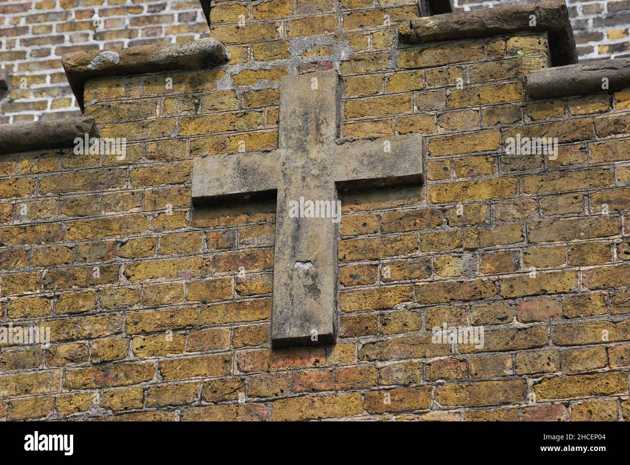Low Angle Shot of a Christian cross from wood an old brick stone wall ...