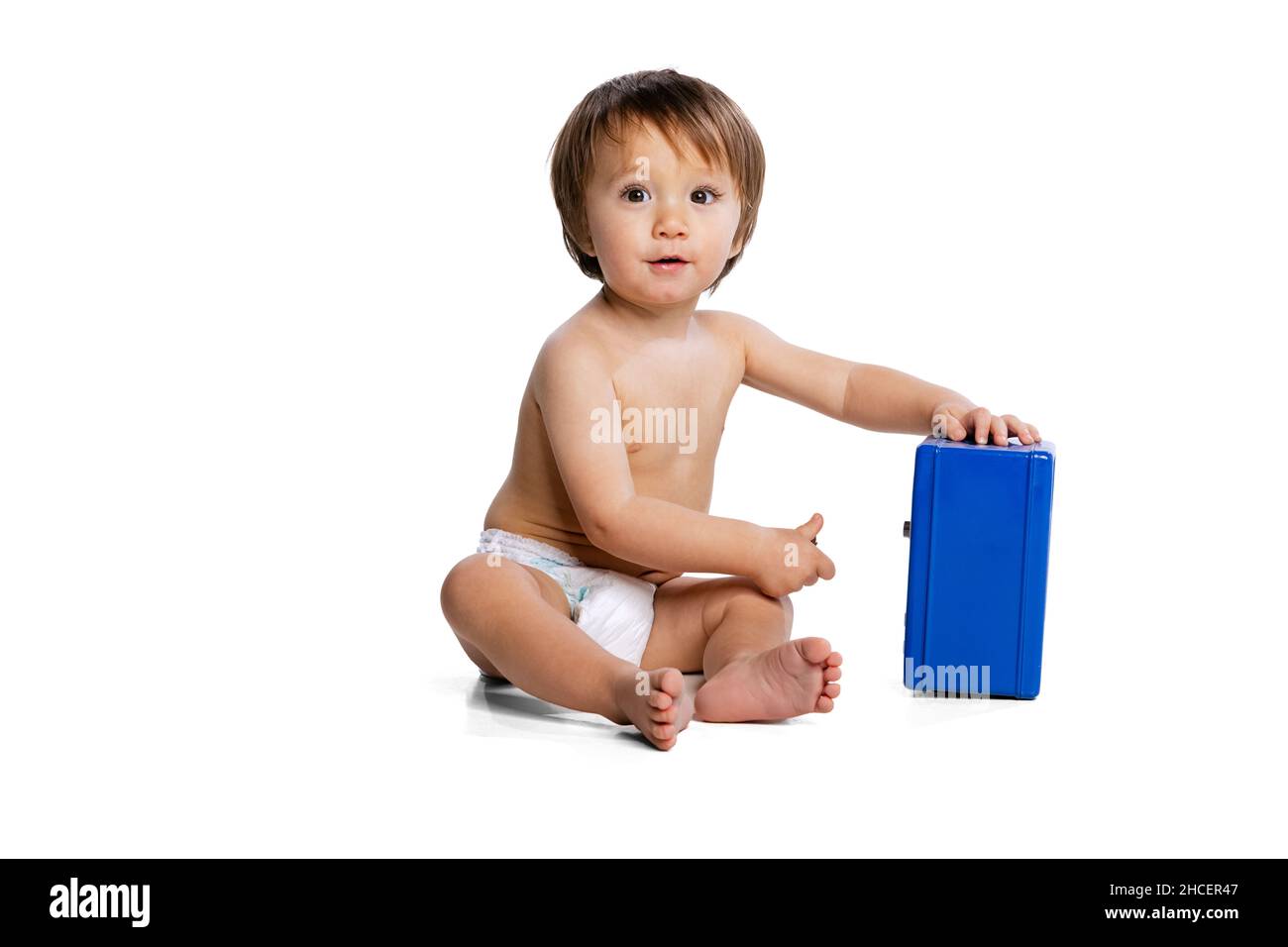 Portrait of little boy, baby, child in diaper playing with toy safe box ...