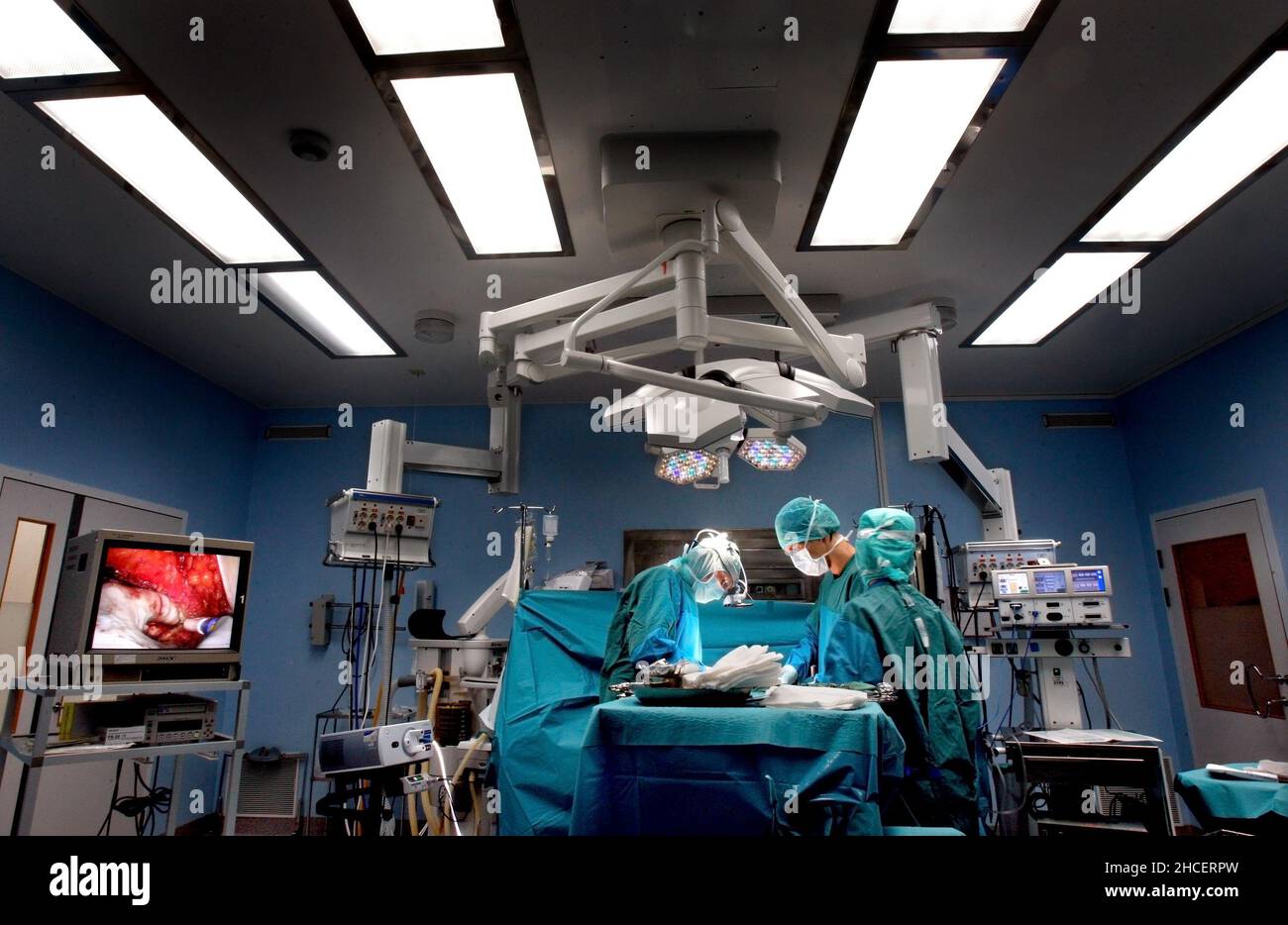 Two doctors operating a patient Stock Photo - Alamy