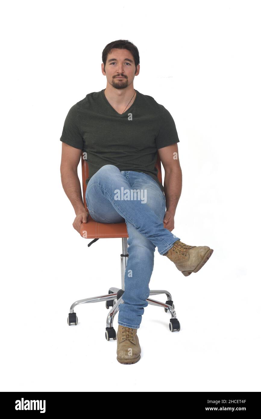 front view of a man looking at camera and legs crossed on white ...