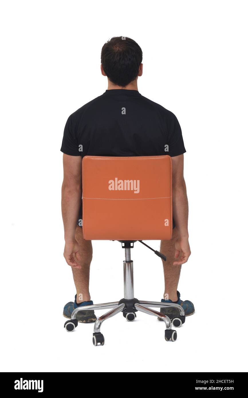 rear view of a full portrait of a man sitting on a chair wearing ...