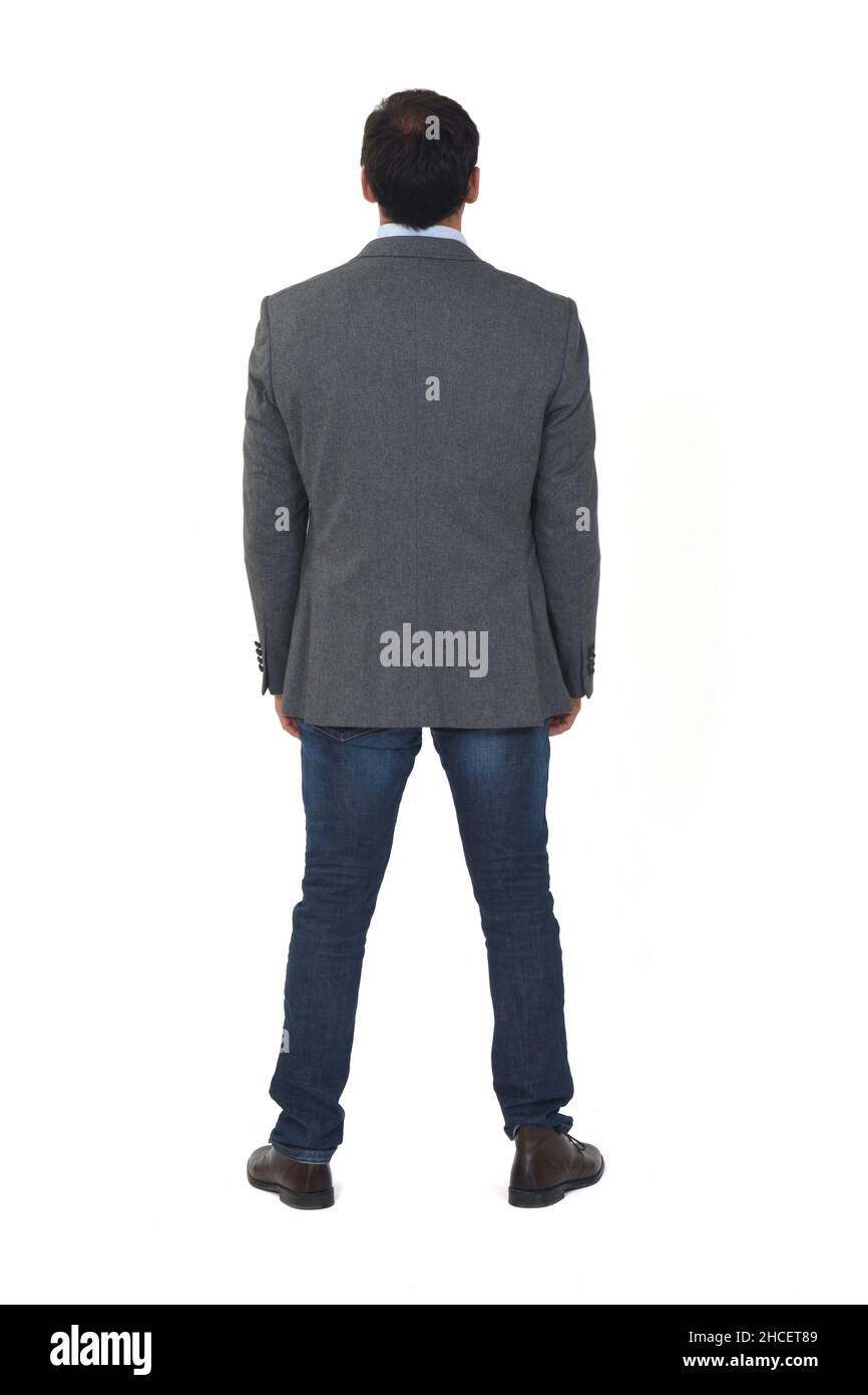 rear view of a man with blazer, jeans and shoes on white background ...
