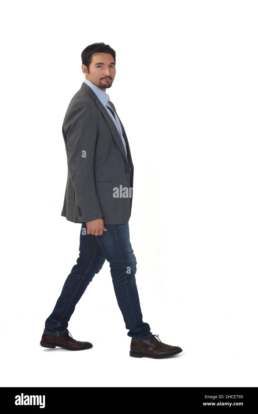 side view of a man with blazer walking on white background Stock Photo ...