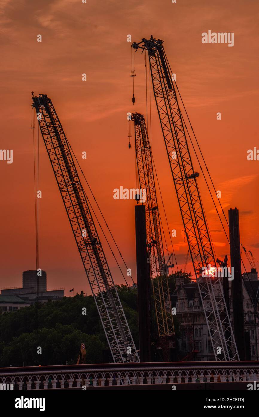 View of the construction area with cranes at scenic sunset Stock Photo ...
