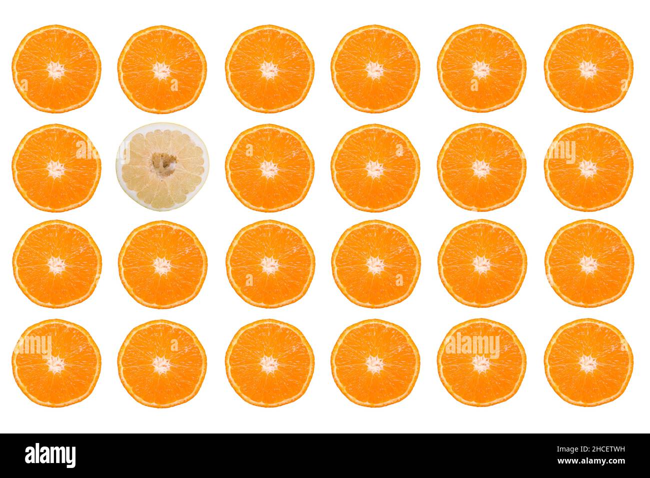 Rows of orange slices and only one pomelo slice isolated on a white ...