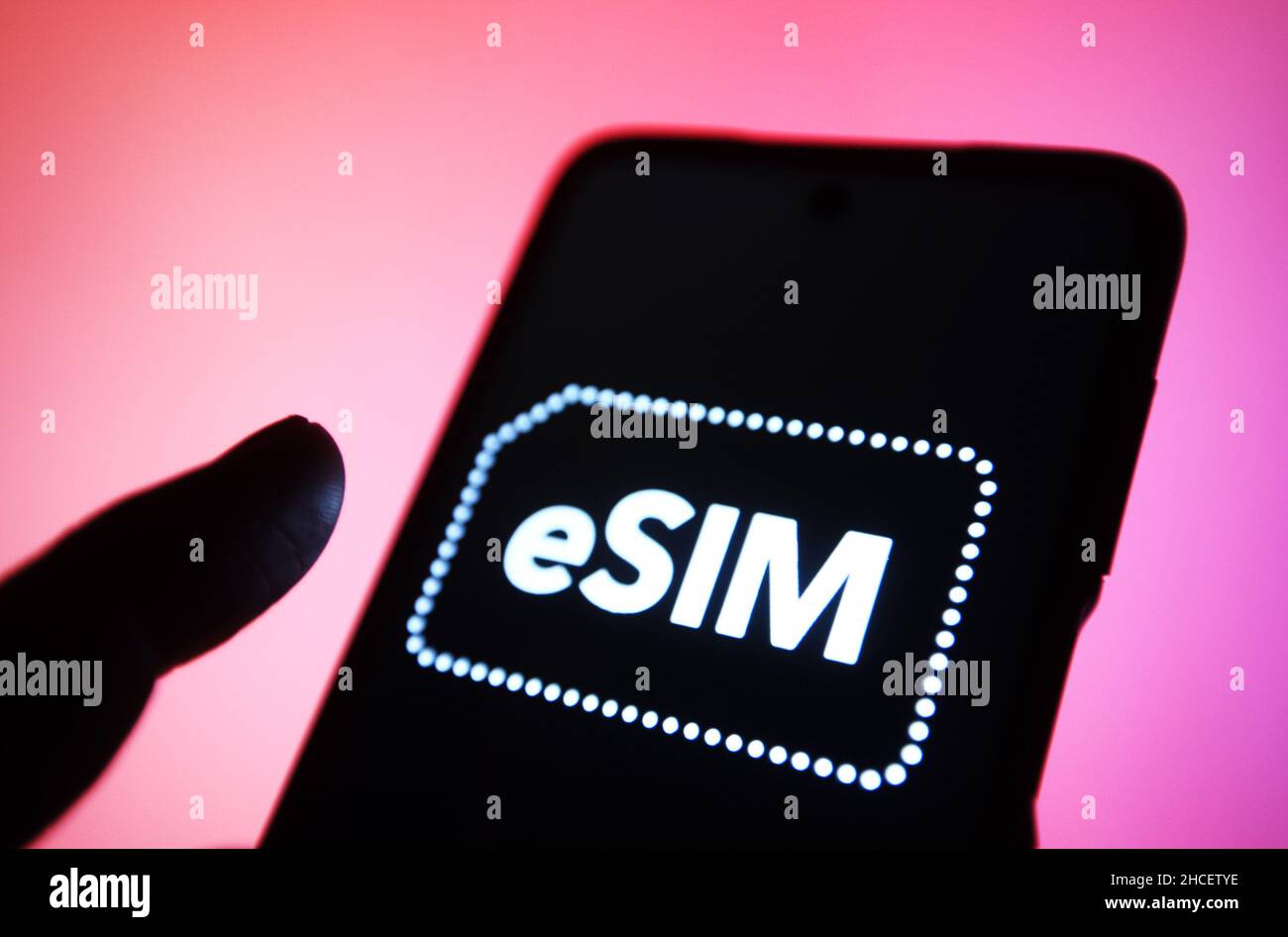 In this photo illustration, eSIM word, name of an embedded integrated ...