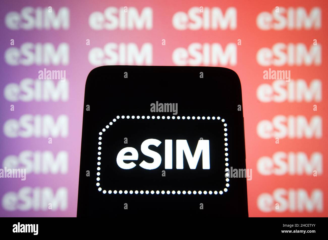In this photo illustration, eSIM word, name of an embedded integrated ...