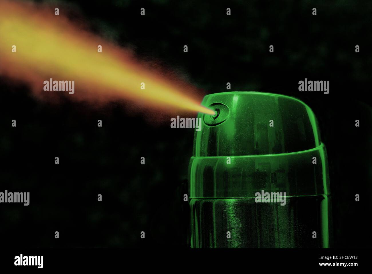 Aerosol deodorant can firing hot colored spray Stock Photo - Alamy
