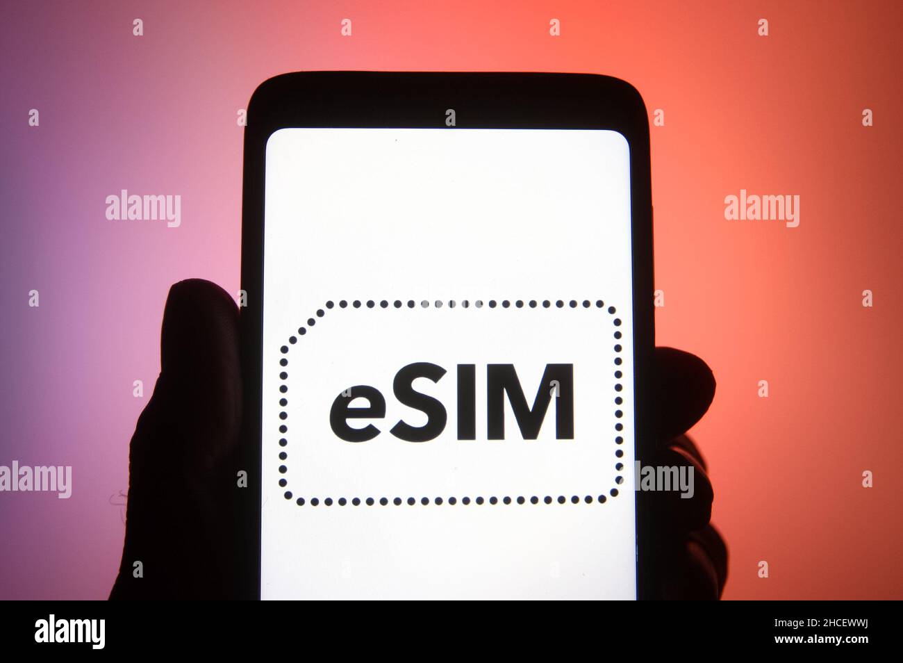 In this photo illustration, eSIM word, name of an embedded integrated ...