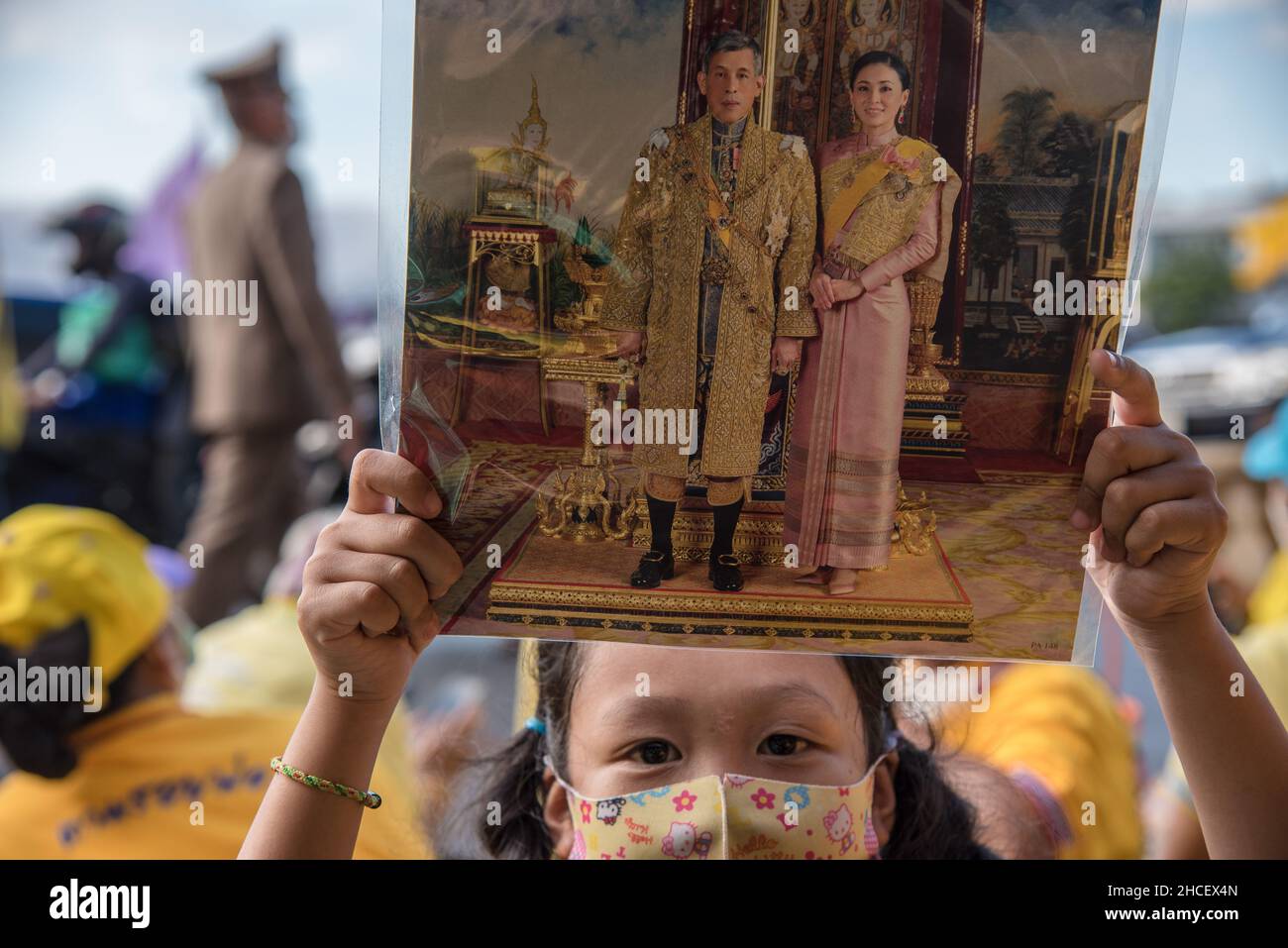 A girl holds the portrait of Thai King Maha Vajiralongkorn and Thai ...