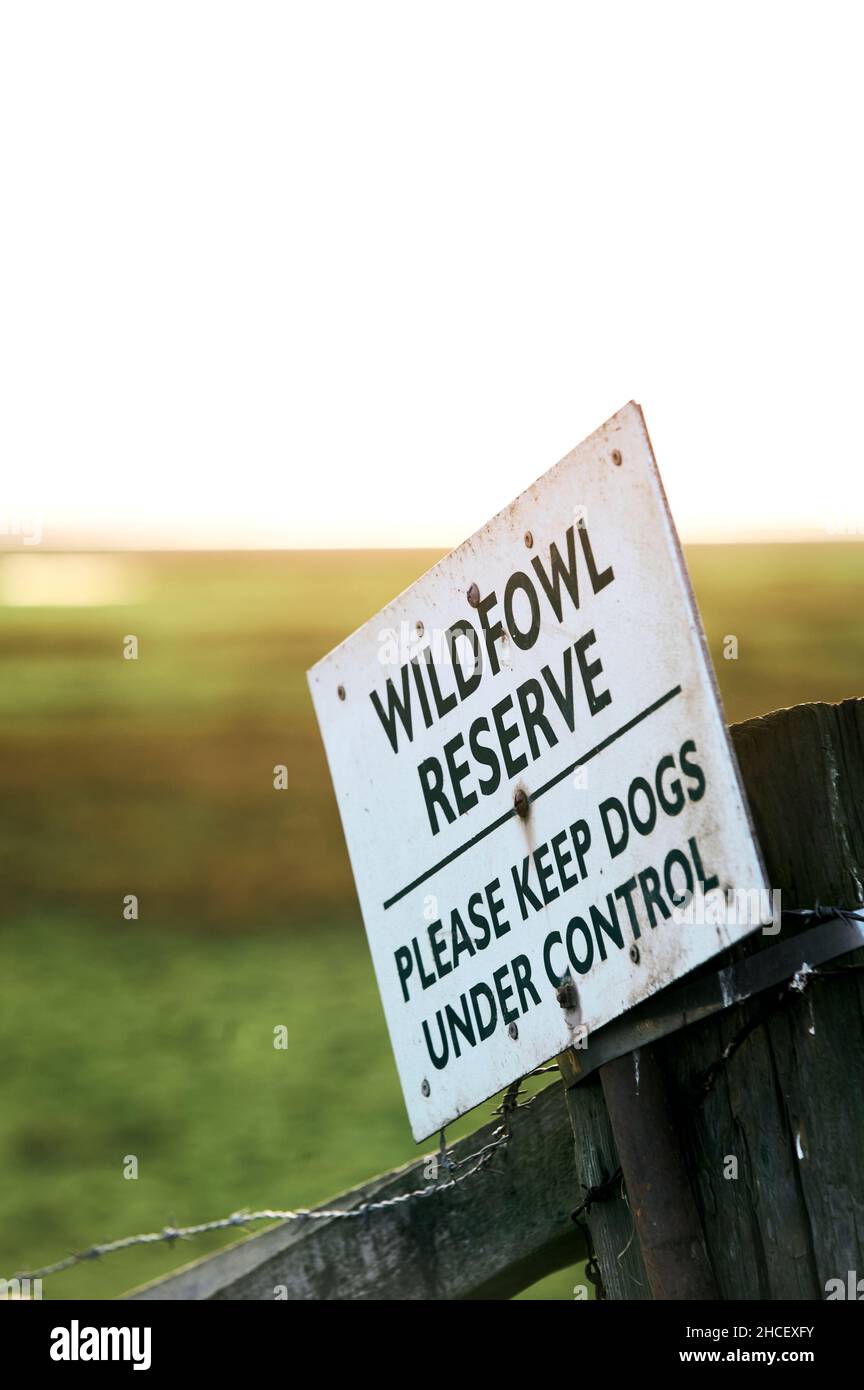 Wildfowl reserve sign on fence and gate post on Lytham salt marsh Stock ...