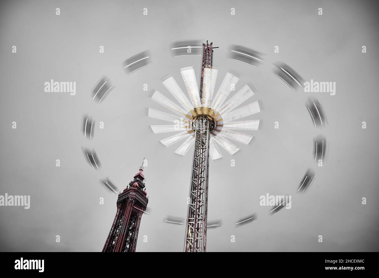 The Star Flyer ride and Blackpool Tower at dusk Stock Photo - Alamy