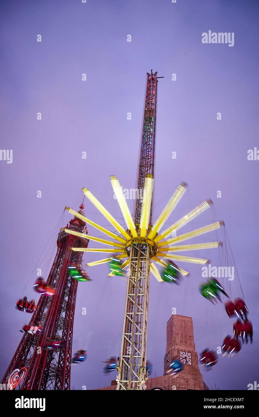 The Star Flyer ride and Blackpool Tower at dusk Stock Photo - Alamy