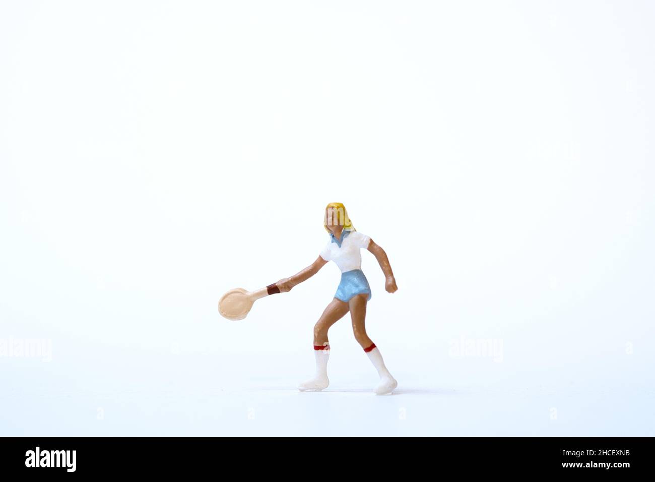Miniature tennis athlete with a tennis racket - white background, copy ...