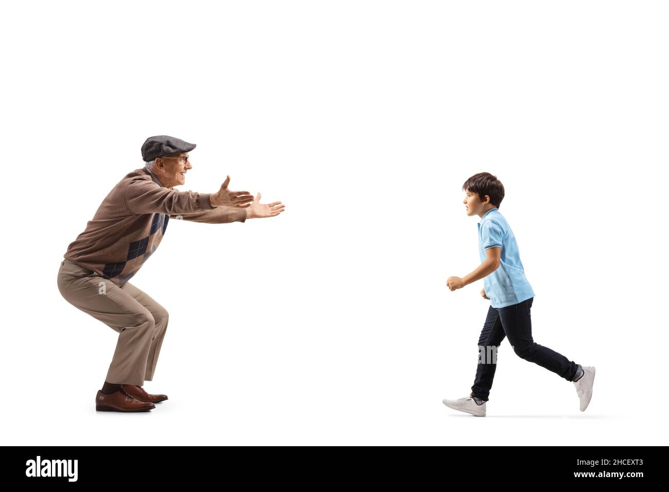 Full length profile shot of a boy running to hug his grandfather ...