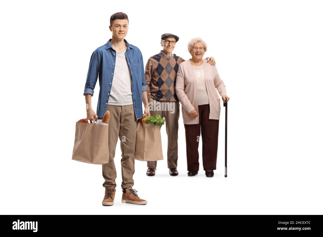 Young man helping an elderly couple and carrying grocery bags isolated ...