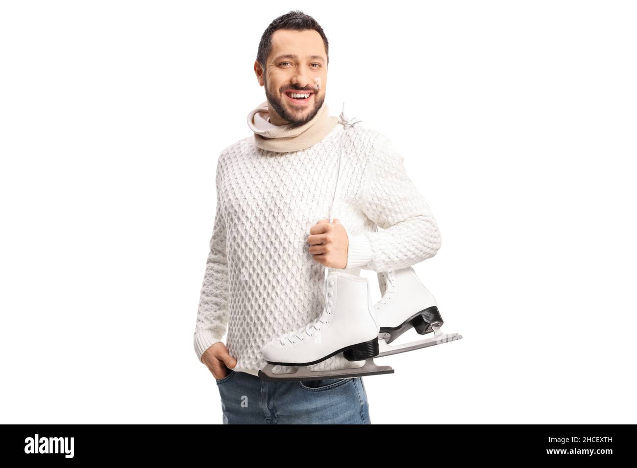 Cheerful young man carrying ice skates on shoulder isolated on white ...
