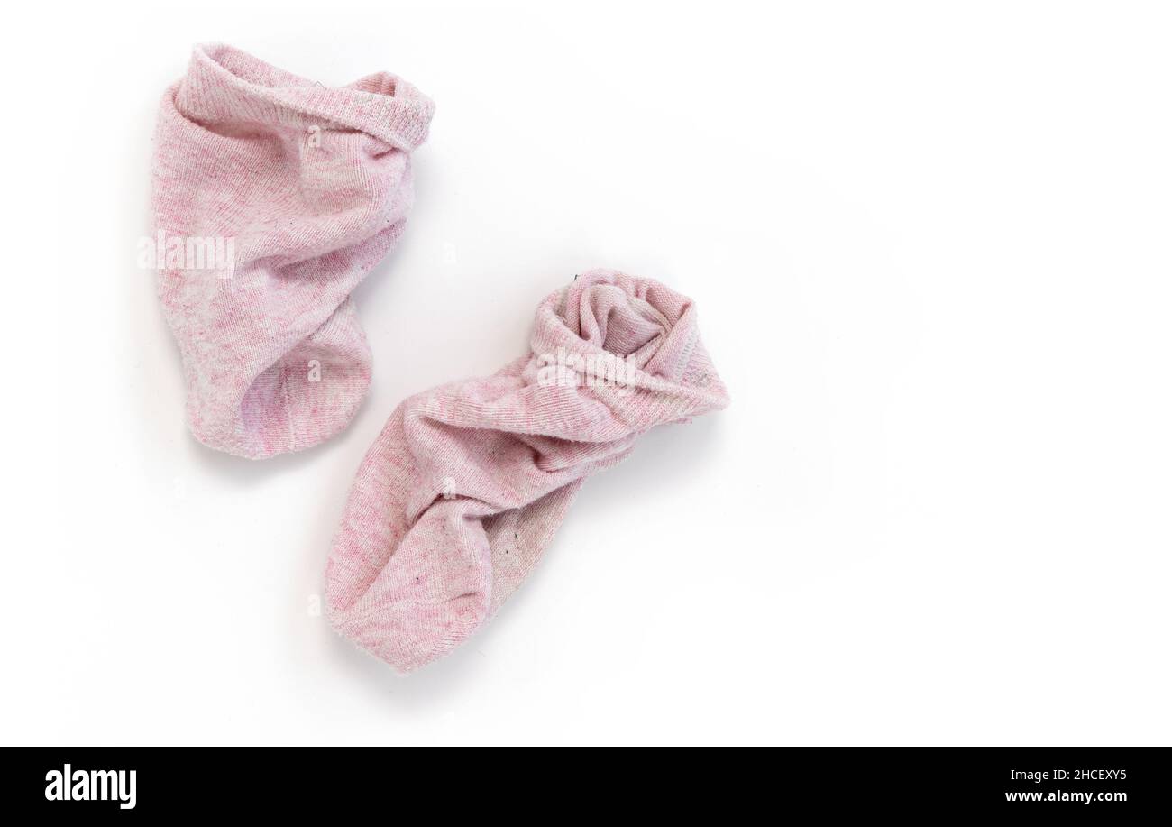 pair of worn socks isolated on white background, pink cotton socks ...